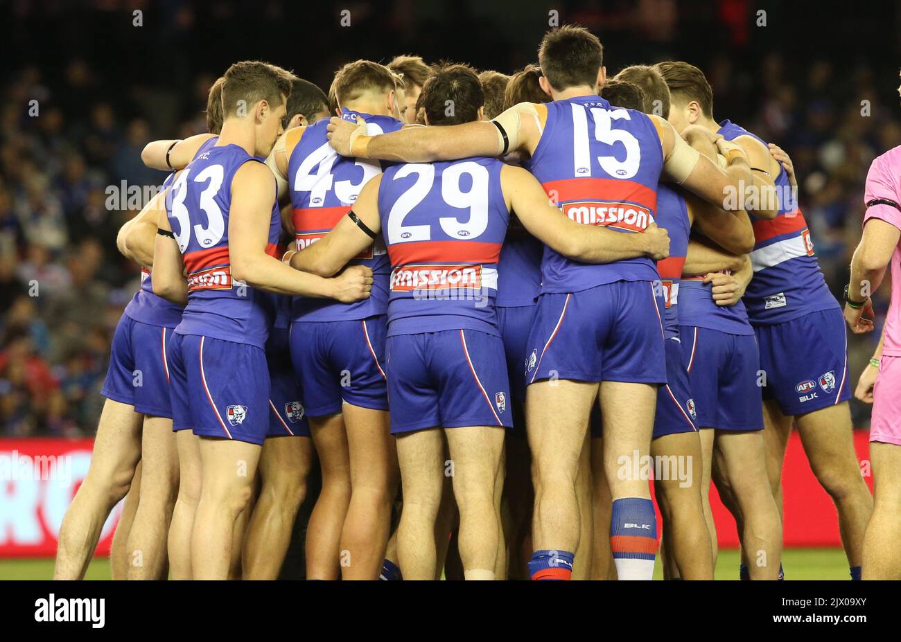 Bulldog players huddle before the game in the round 20 AFL match ...