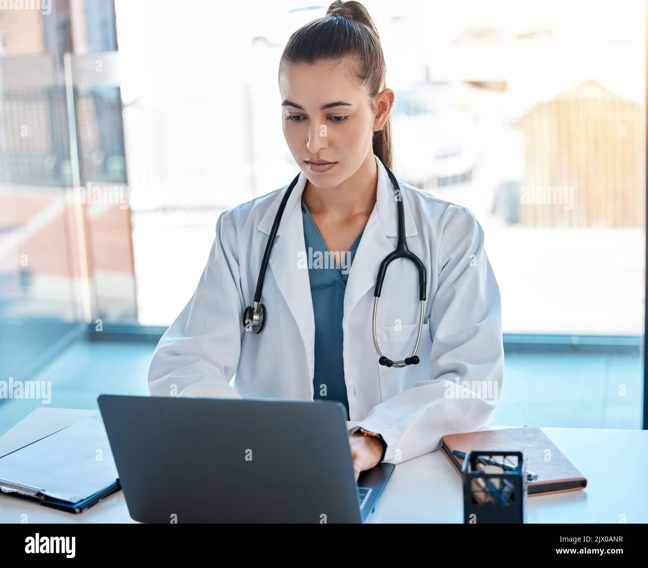 Doctor typing in office hi-res stock photography and images - Alamy
