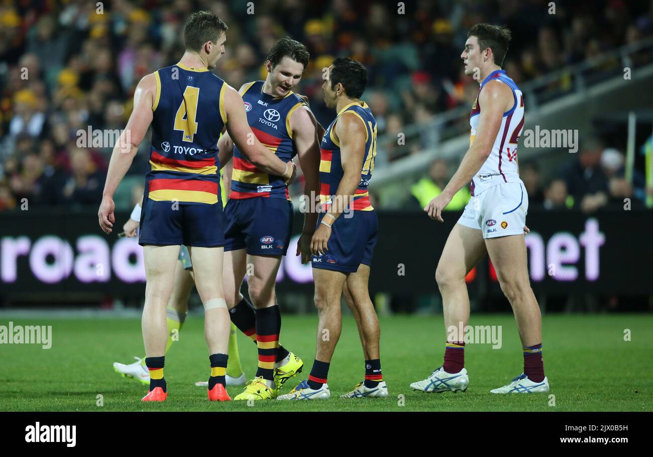Patrick Dangerfield of the Crows is congratulated by team mates Josh ...