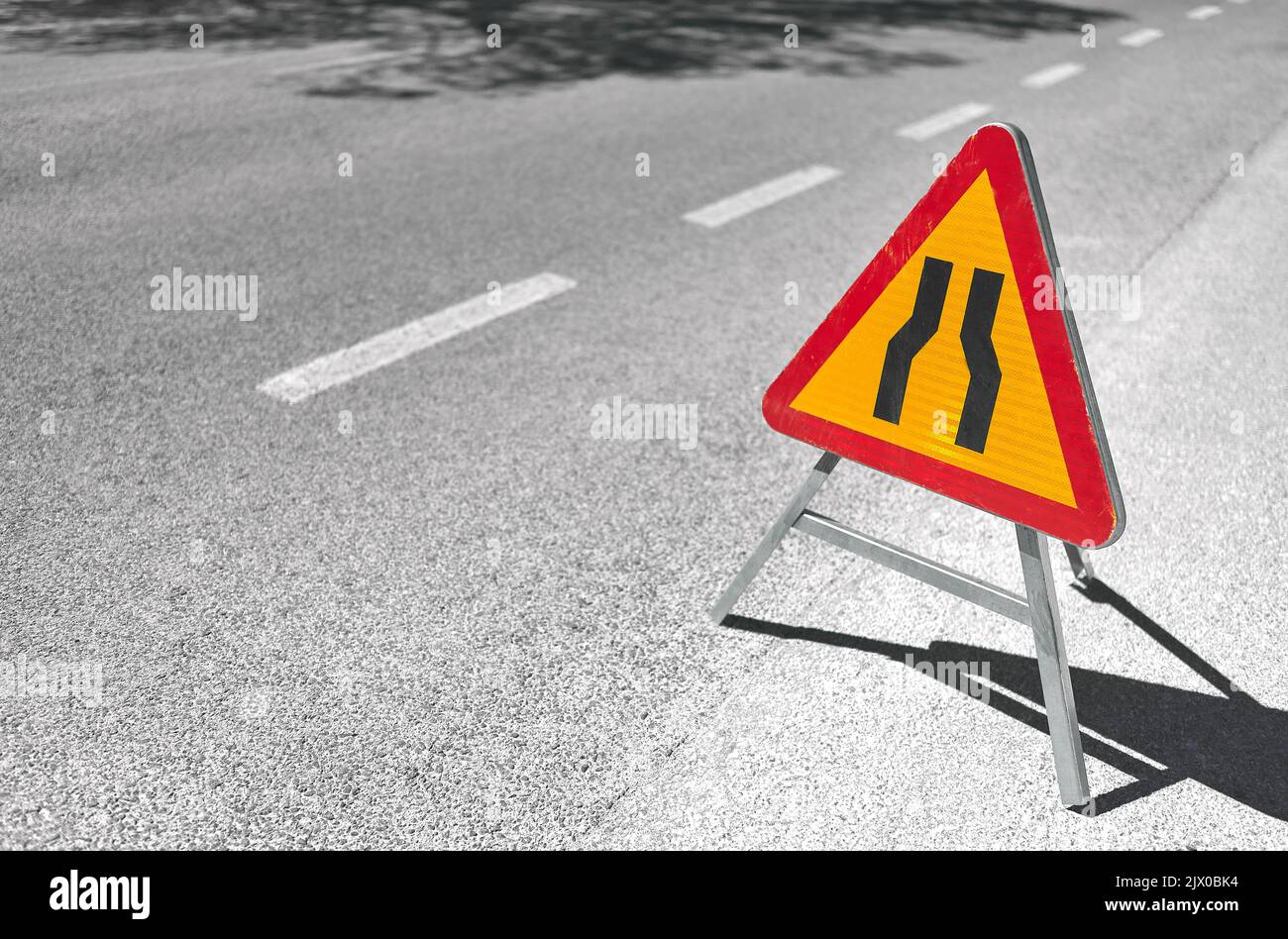 detail of a traffic sign indicating the narrowing of the road due to ...