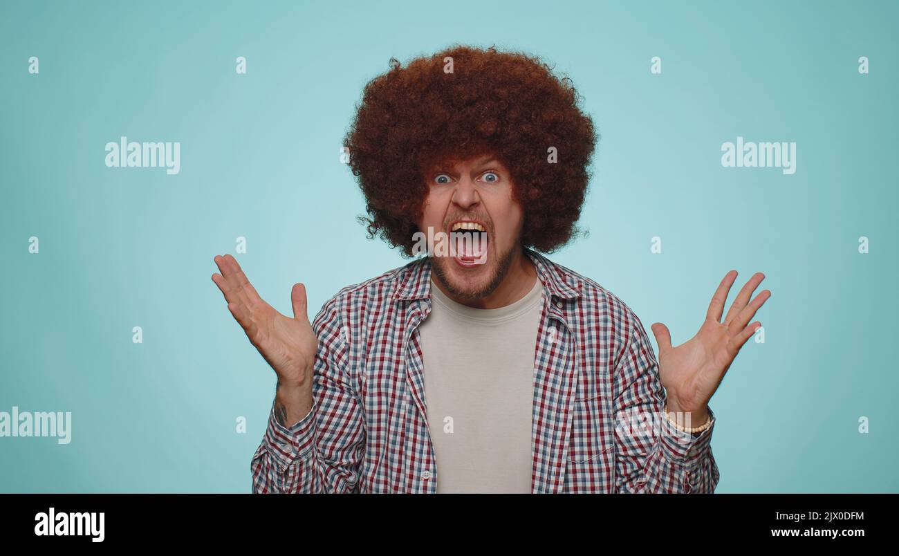 Bearded adult man scared fearful, covering ears with hands, closing ...