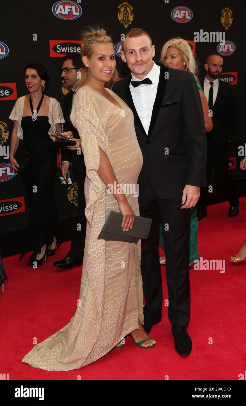 Brisbane Lions player Mitch Robinson and his partner Emma MacNeil poses ...