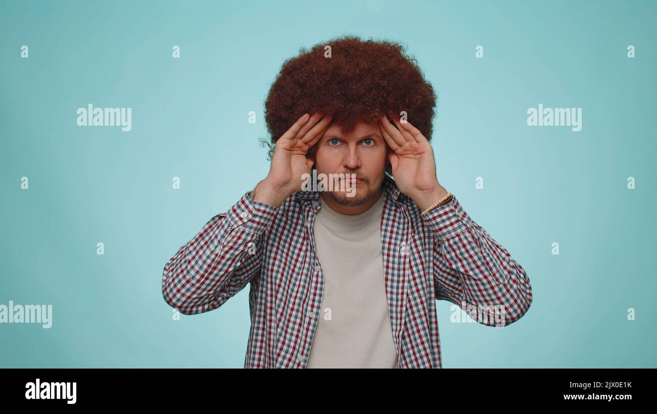 Nosy curious man closing eyes with hand and spying through fingers ...