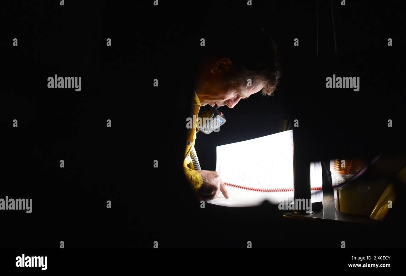 CFA crews check local maps as they help crews to blackout spot fires ...