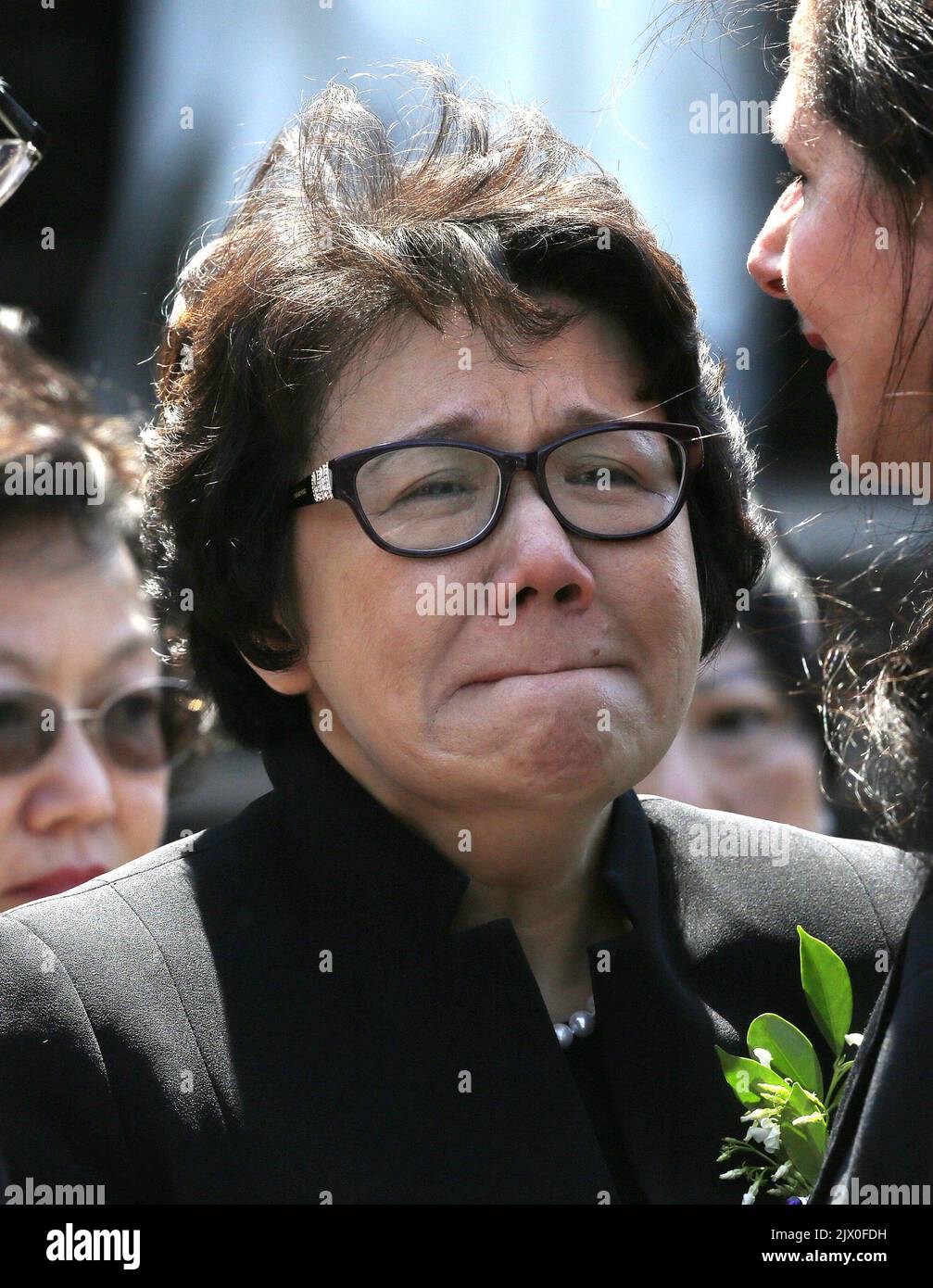 Selina Cheng, the wife of Curtis Cheng, is overcome with emotion after ...