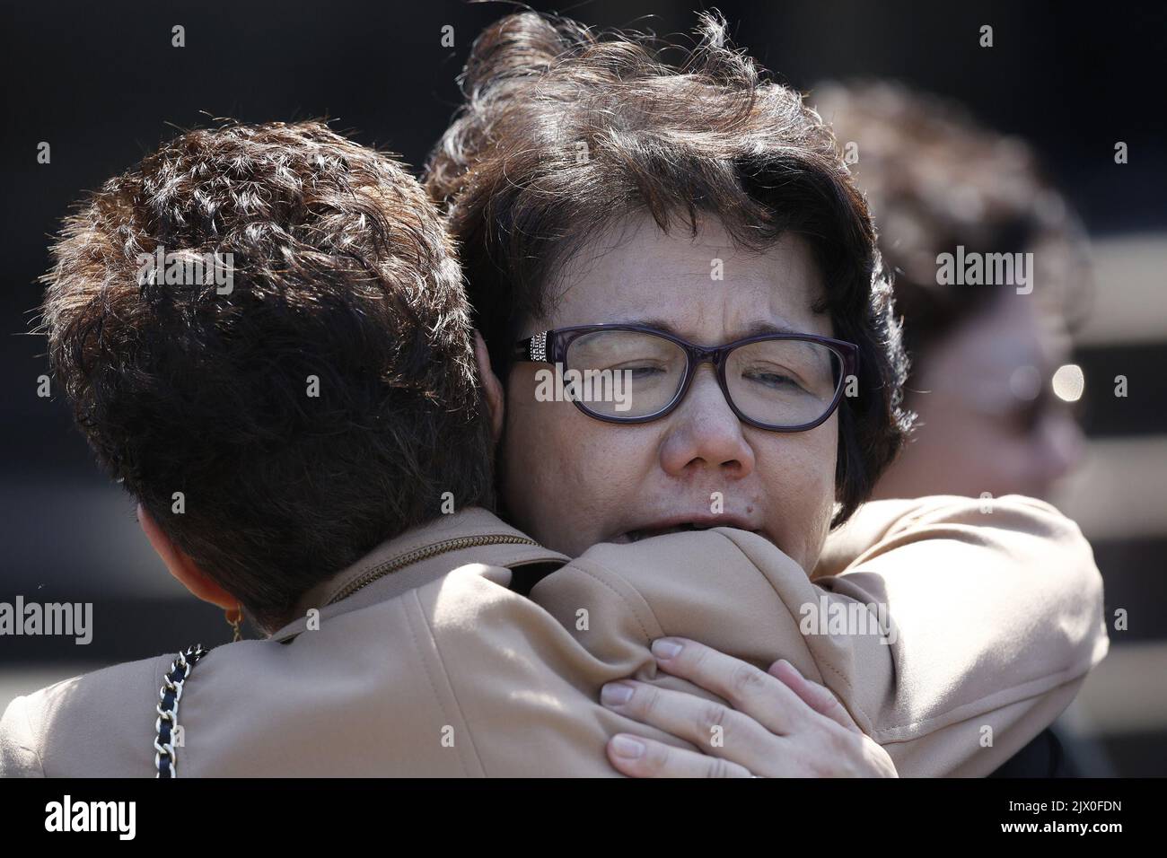 Selina Cheng, the wife of Curtis Cheng, is consoled by a friend after ...