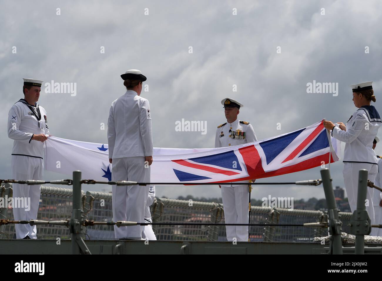 Commanding Officer Lieutenant Commander David Murphy, (centre), looks ...