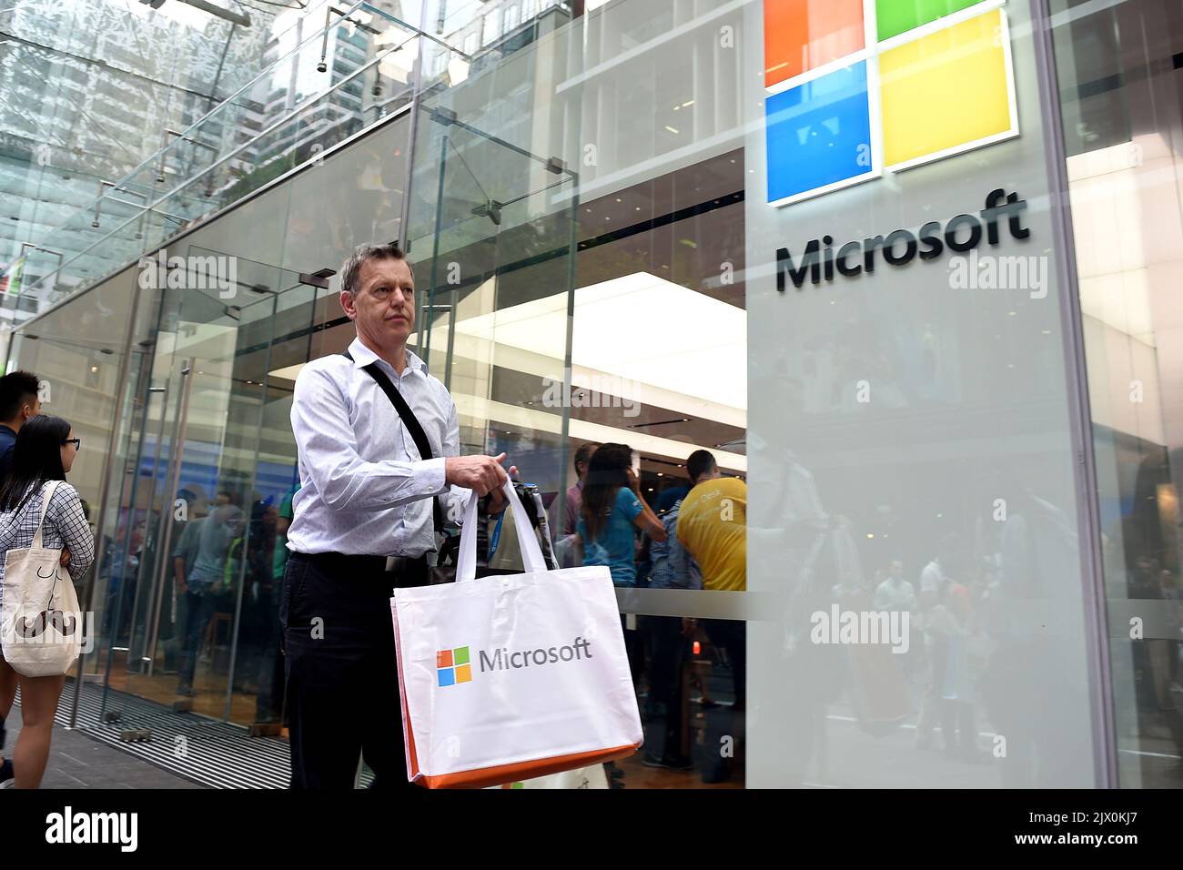 Customers are seen attending the grand opening of the Microsoft ...