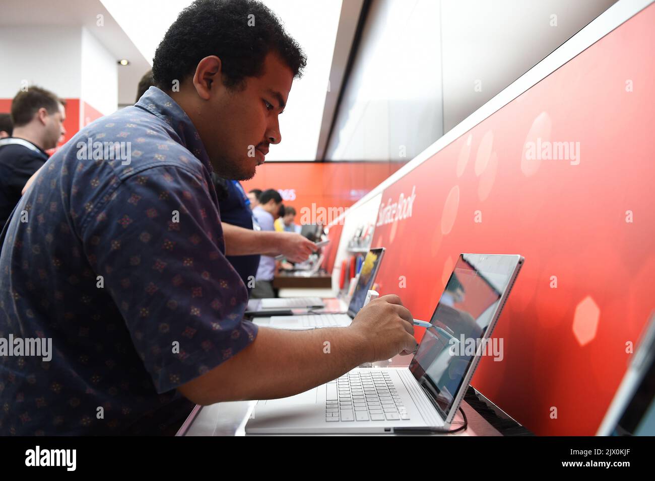 Customers are seen attending the grand opening of the Microsoft ...