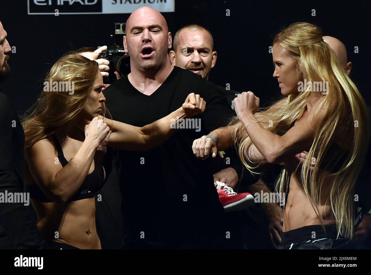 Ronda Rousey (left) and Holly Holm scuffle during a face-off after the ...