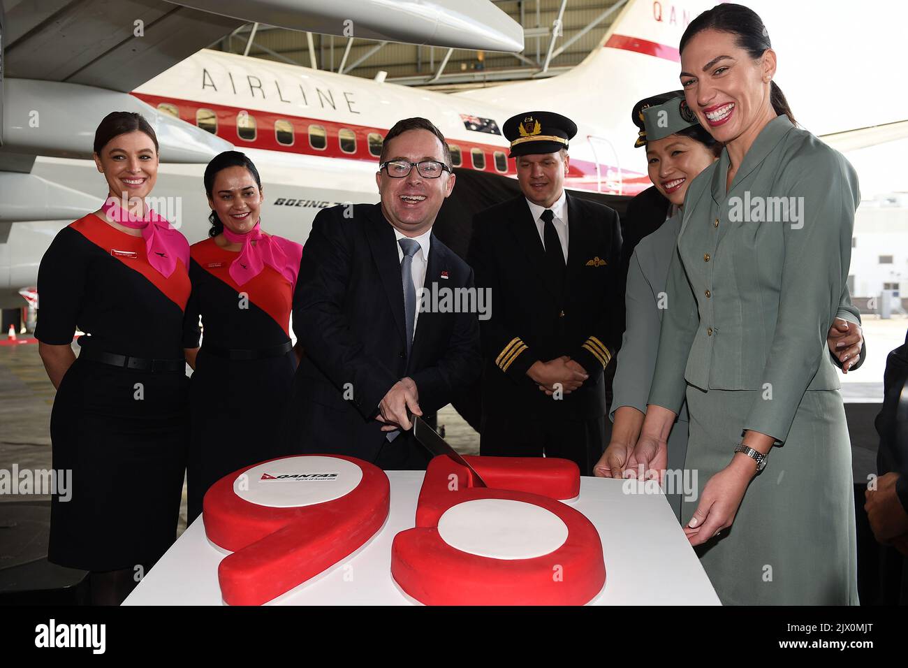 Qantas CEO Alan Joyce is seen cutting a cake at the unveiling of the ...