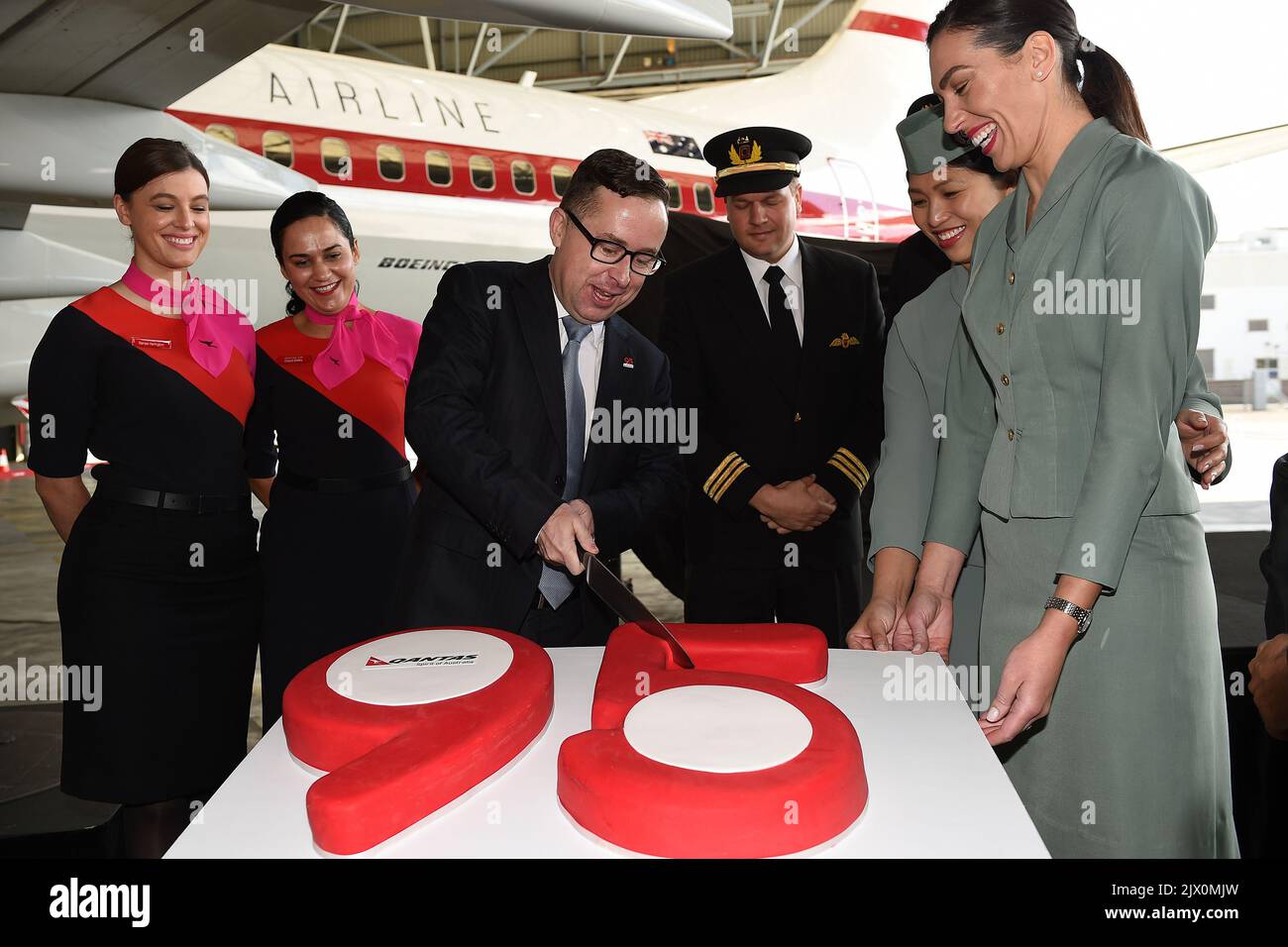 Qantas CEO Alan Joyce is seen cutting a cake at the unveiling of the ...