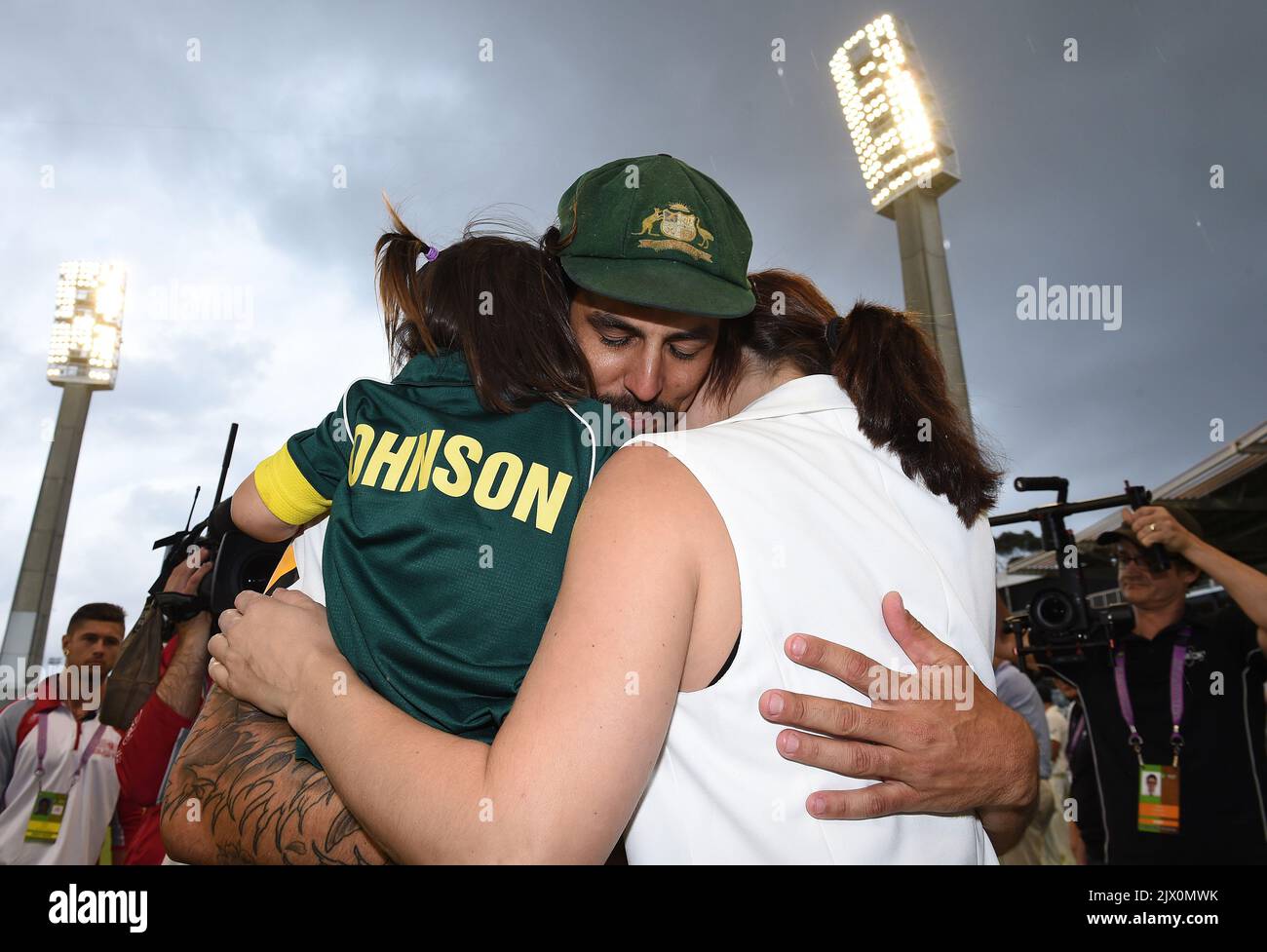 Australian cricketer Mitchell Johnson hugs his wife and daughter at ...