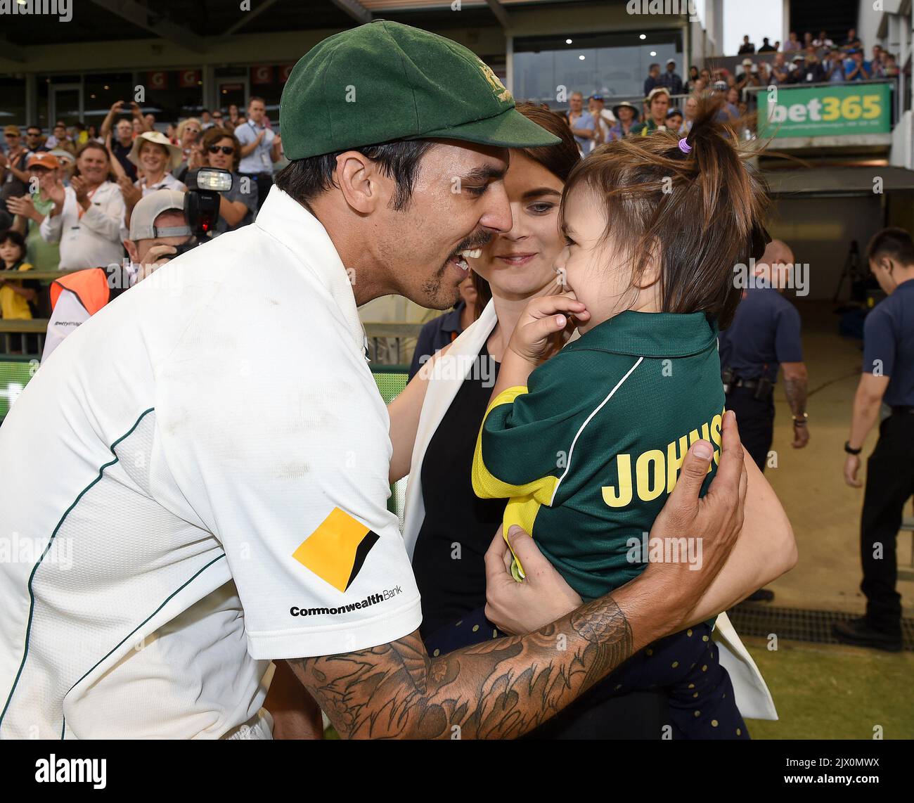 Australian cricketer Mitchell Johnson reacts with his wife and daughter ...