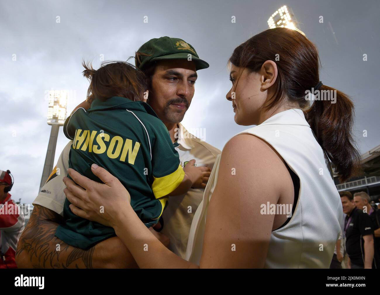 Australian cricketer Mitchell Johnson reacts with his wife and daughter ...