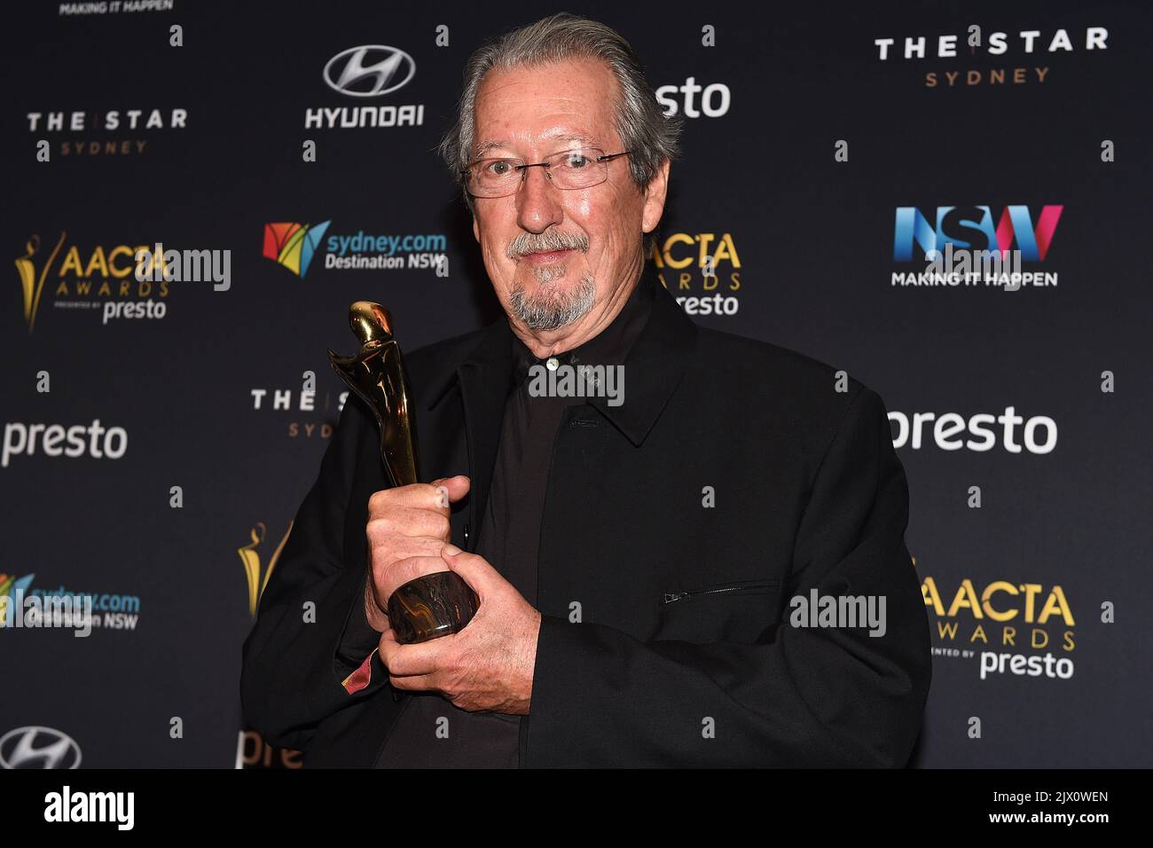 Australian actor Michael Caton poses for a photograph after winning the ...