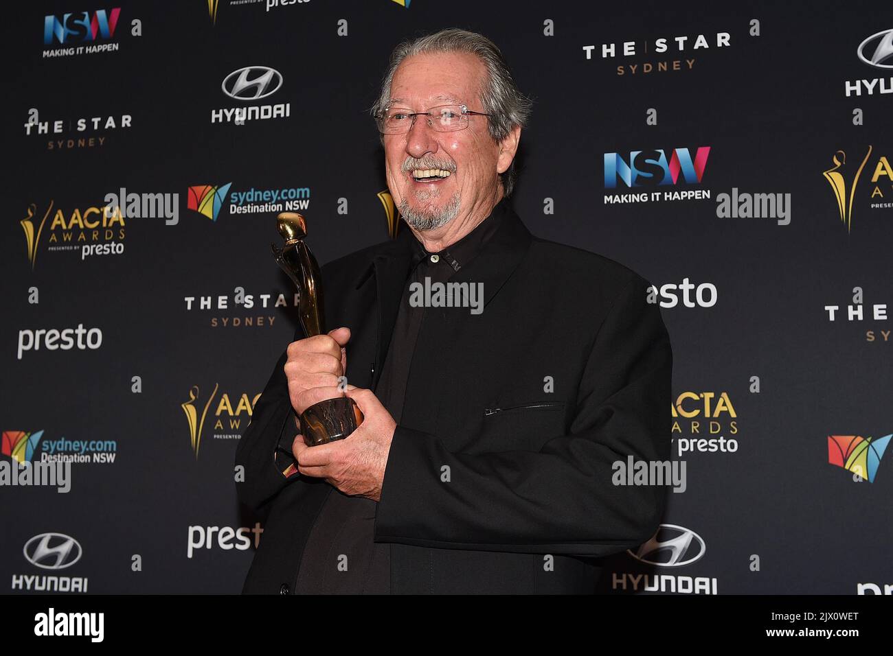 Australian actor Michael Caton poses for a photograph after winning the ...