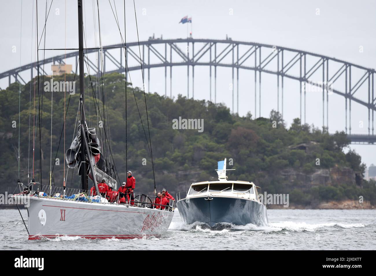 Wild Oats XI (left) returns to dock after retiring from the Sydney ...