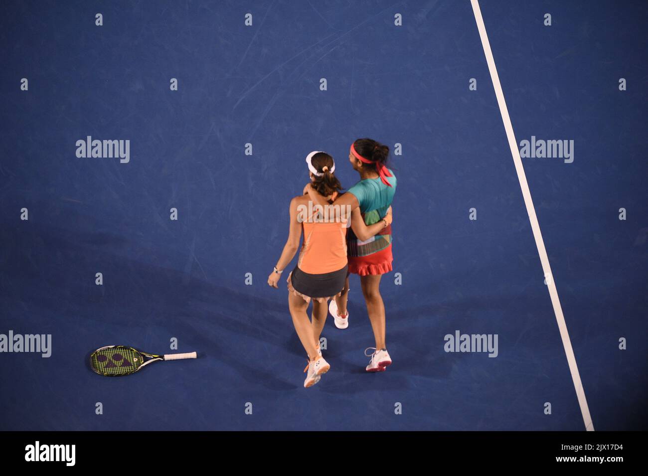 Martina Hingis of Switzerland (left) Sania Mirza of India (right) react ...