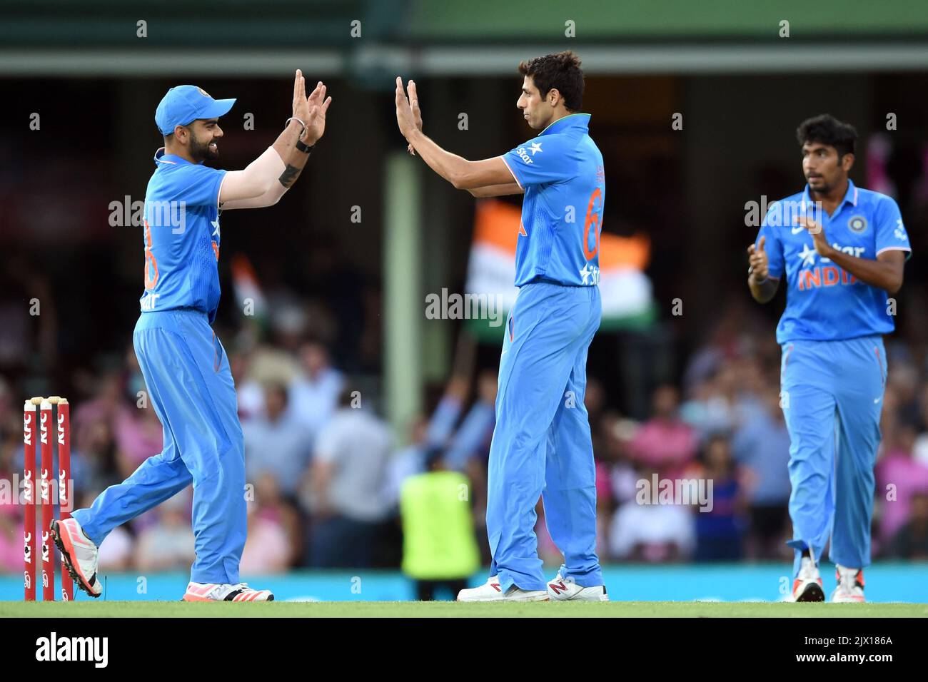 India's Ashish Nehra (centre) is congratulated by Virat Kohli (left ...