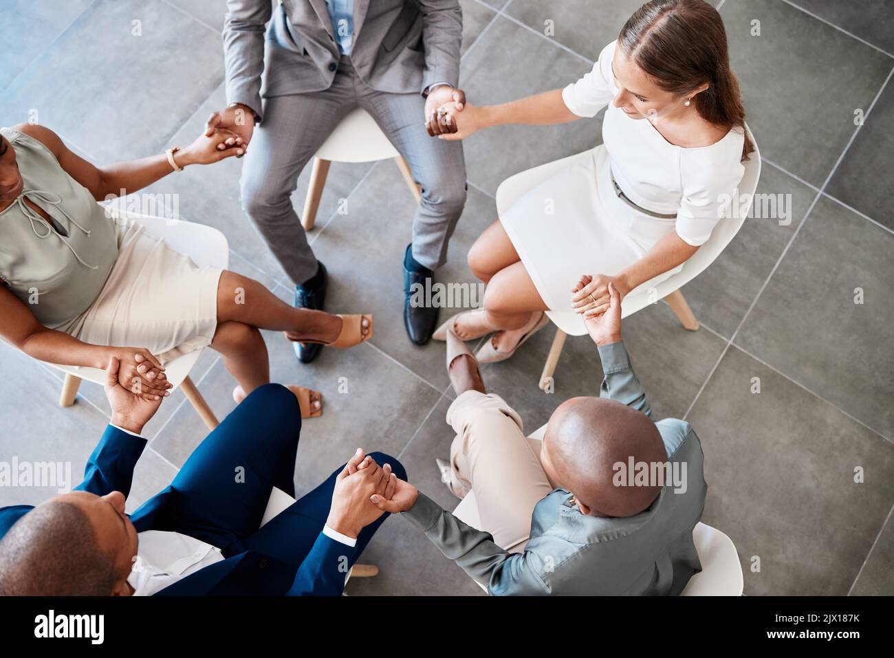 Diversity, support and collaboration of business people holding hands above in trust for company ...