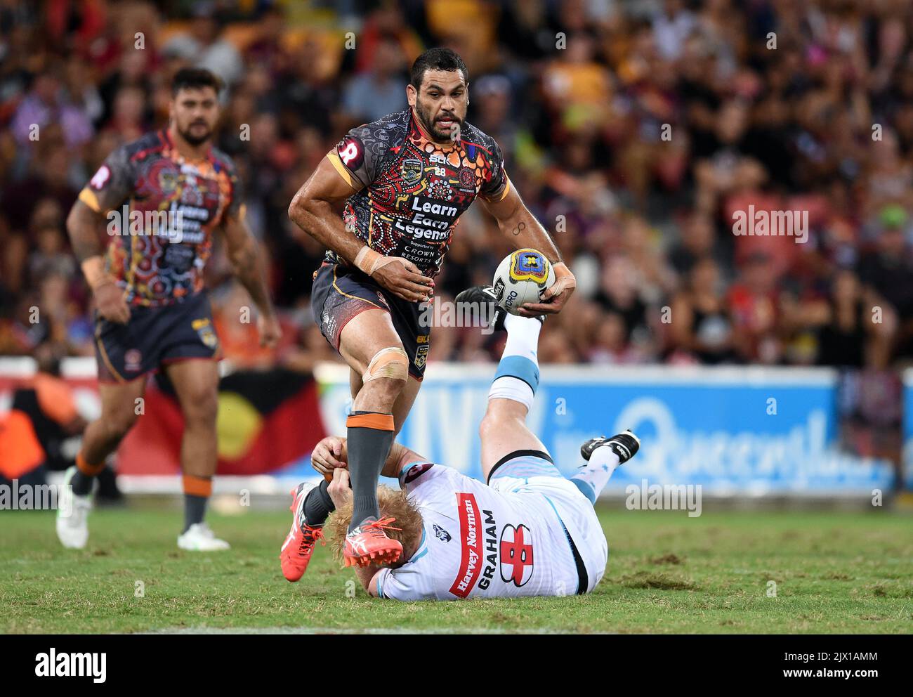 Greg Inglis of the Indigenous All Stars jumps over James Graham of the ...