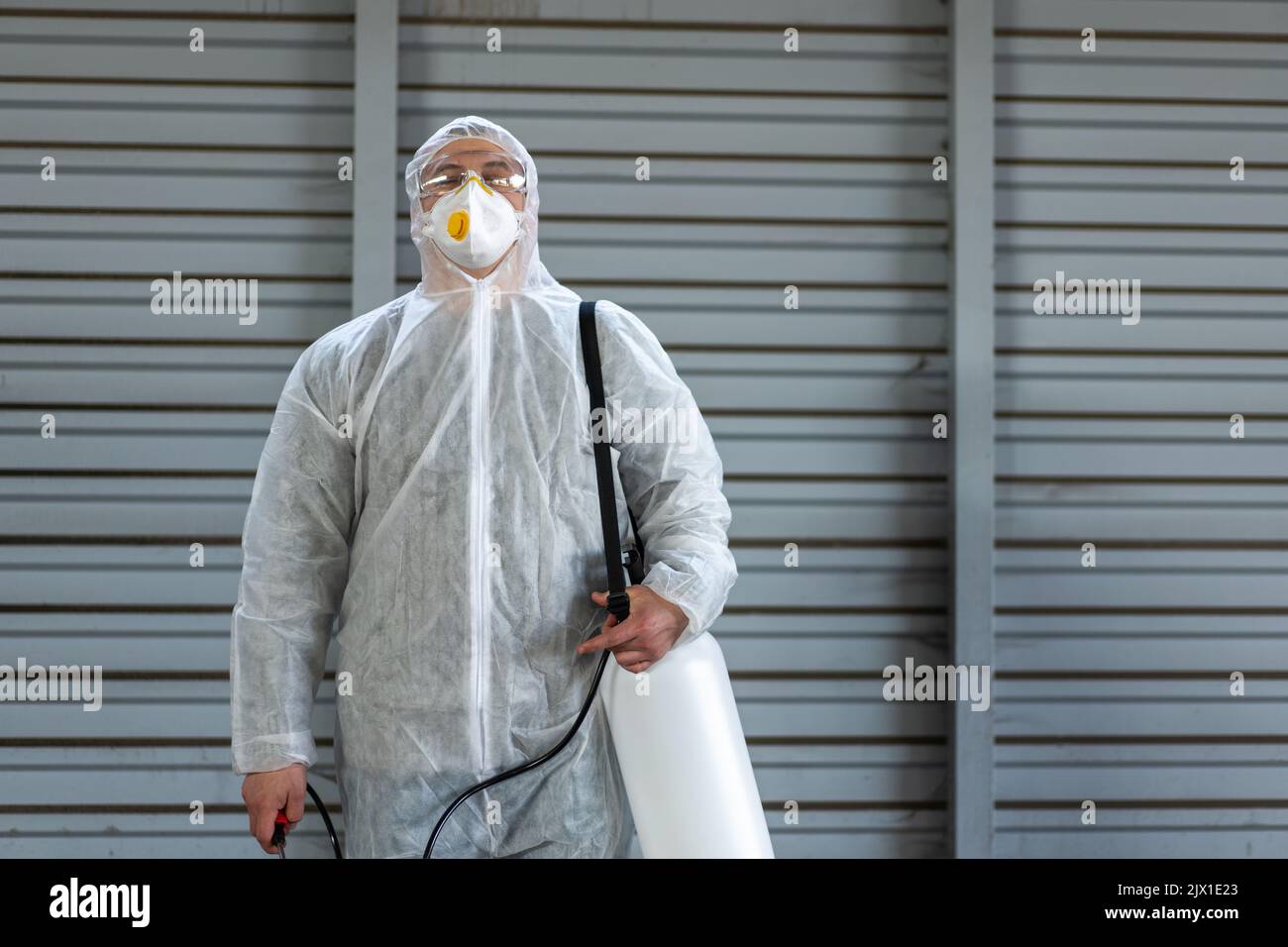 Worker wearing protective suit disinfection gear disinfect surface ...