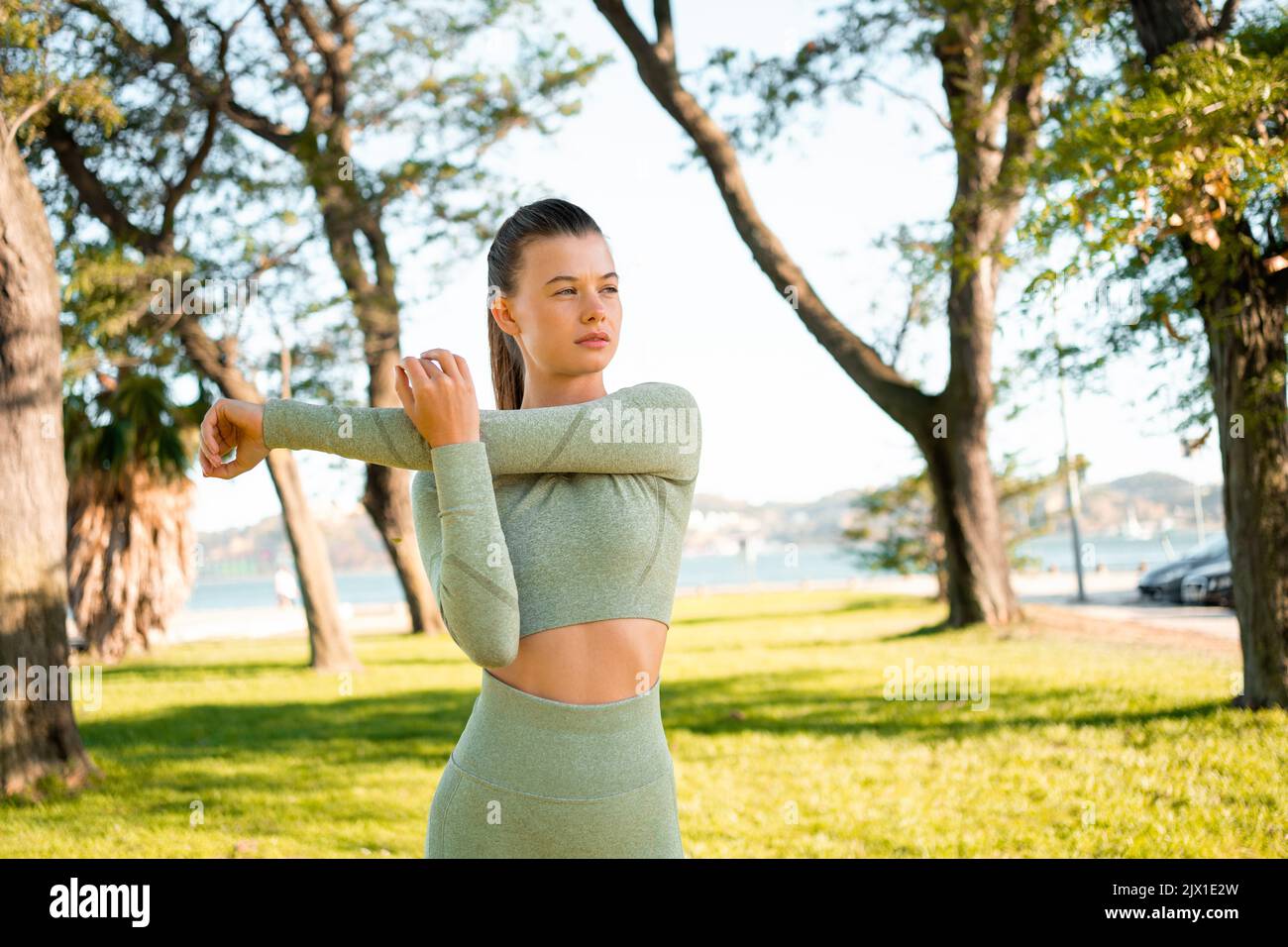 Woman Stretching And Warming-Up Before Running. Fit sport woman stretching her body warm up ...