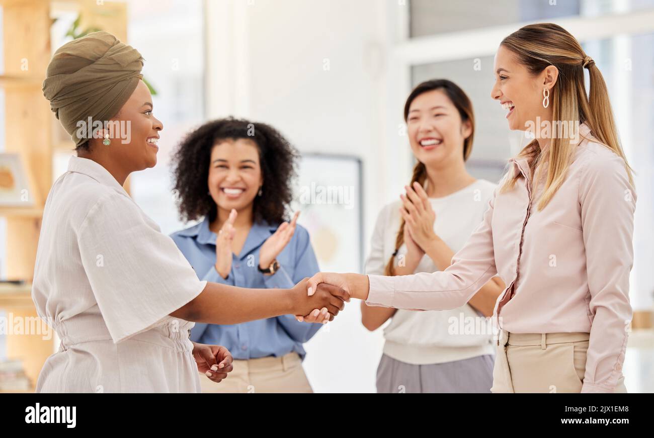 Handshake, promotion or welcome, happy business women meeting in office ...