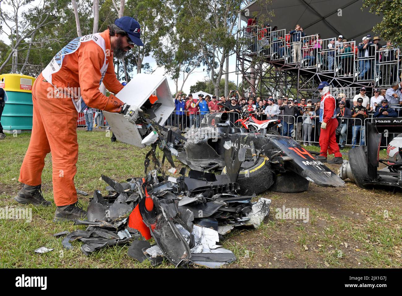 Safety marshals pile up bits of Fernando Alonso's Mclaren F1 car after ...