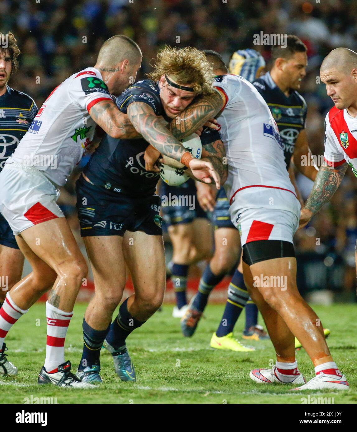 Cowboys Ethan Lowe is wrapped up by Dragons defence during round 5 NRL ...