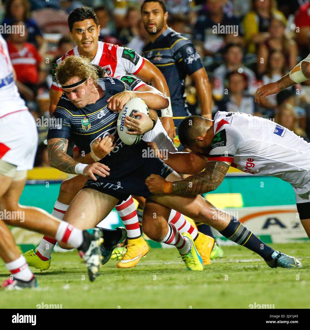 Cowboys Ethan Lowe tackled by Dragons Leeson Ah Mau, right, during ...