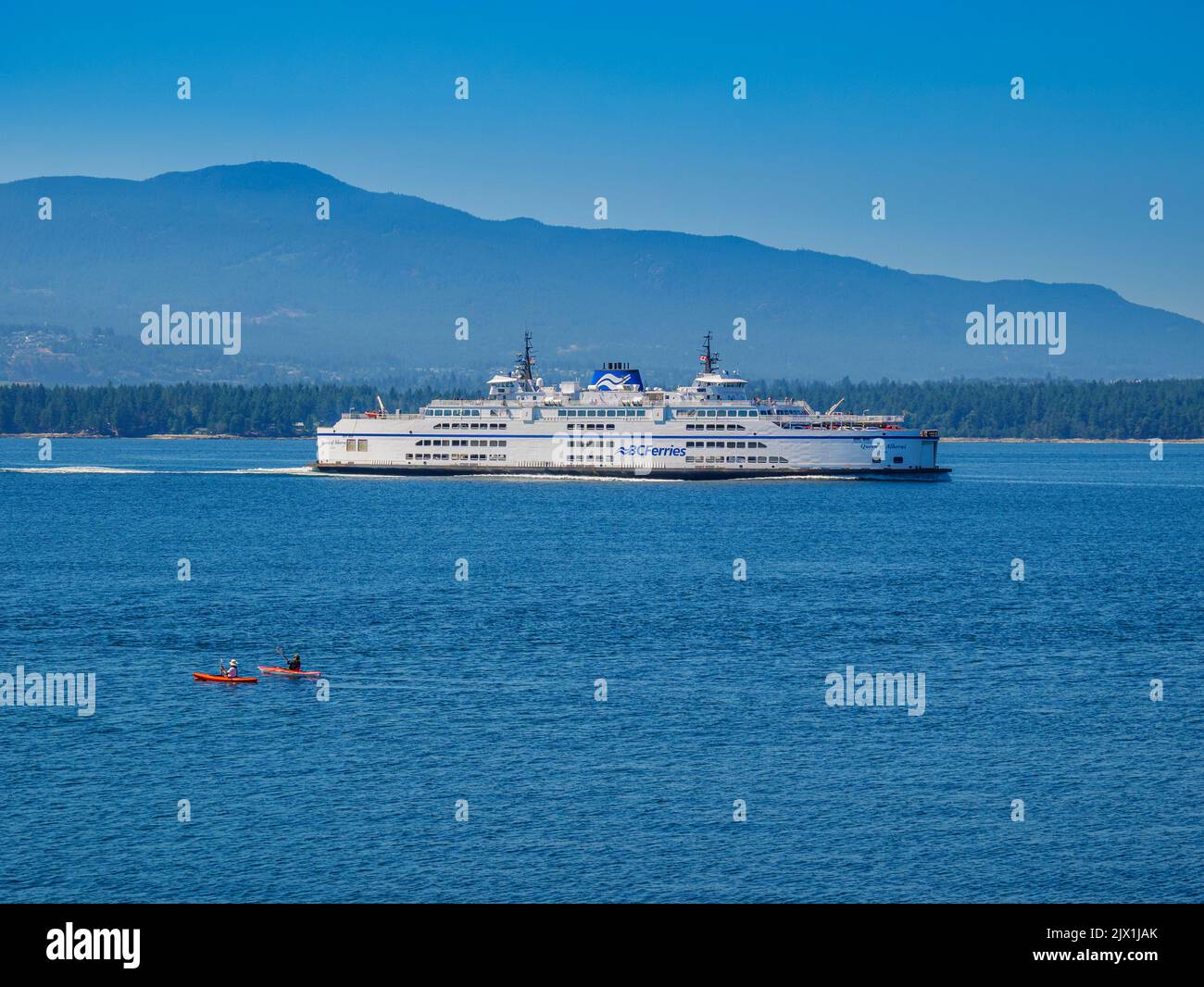 Two kayakers watching a BC Ferries vessel sail past Stock Photo - Alamy