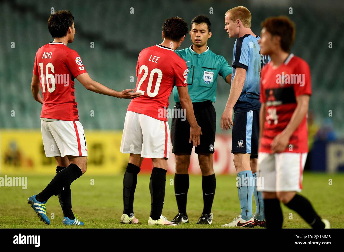 Lee Tadanari of the Urawa Red Diamonds argues a penalty call by referee ...