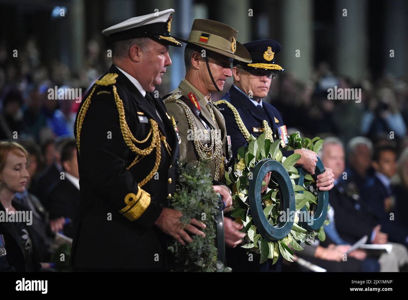 Representatives of the Australian Navy, Army and Air Force lay wreaths ...