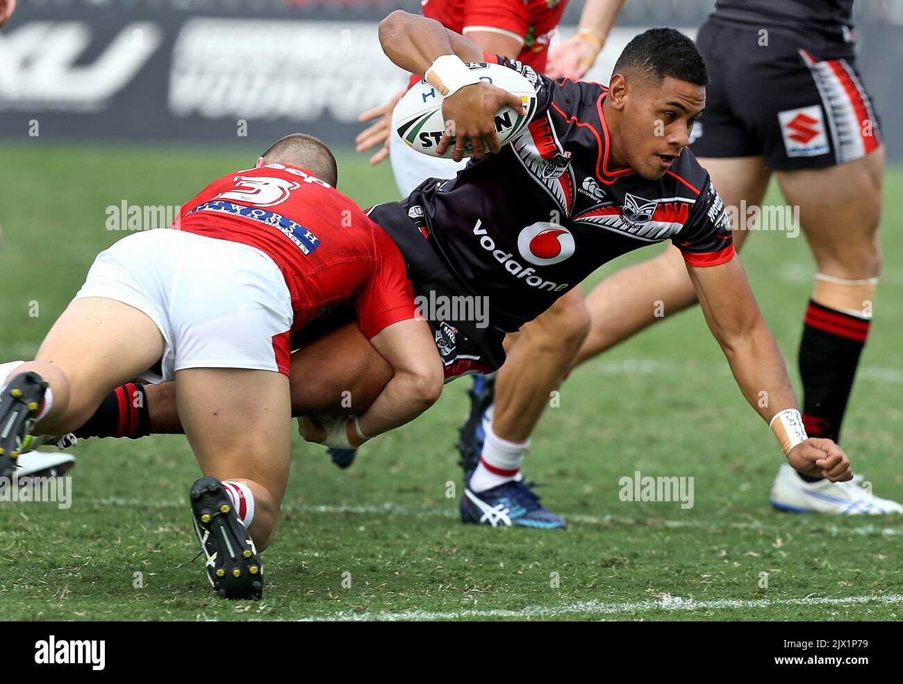 David Fusitu`a of the Warriors is tackled by Euan Aitken of the Dragons ...