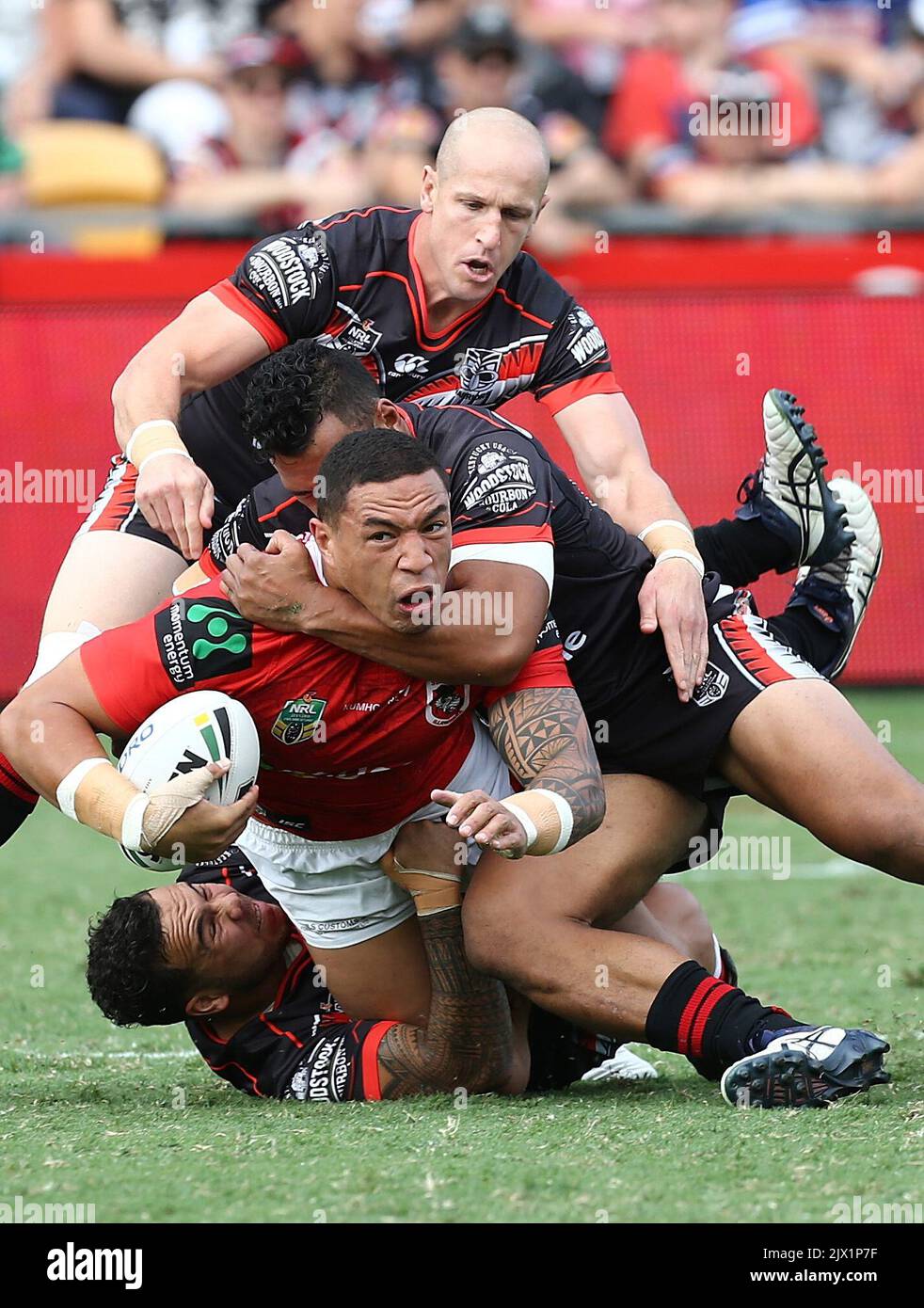 Tyson Frizell of the Dragons is tackled by Jeff Robson, top, Jazz ...