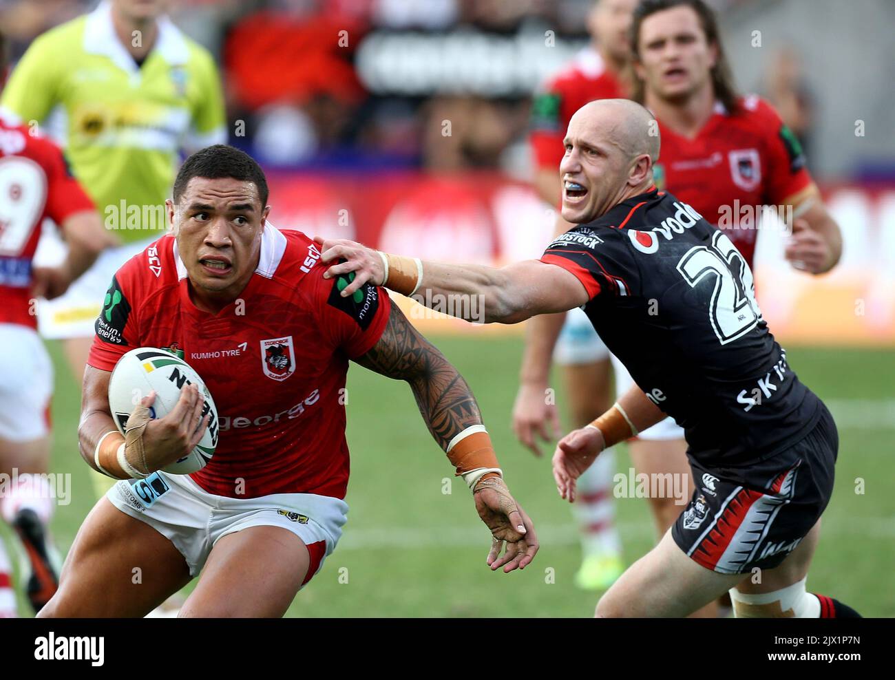 Tyson Frizell of the Dragons avoids a challenge from Jeff Robson of the ...