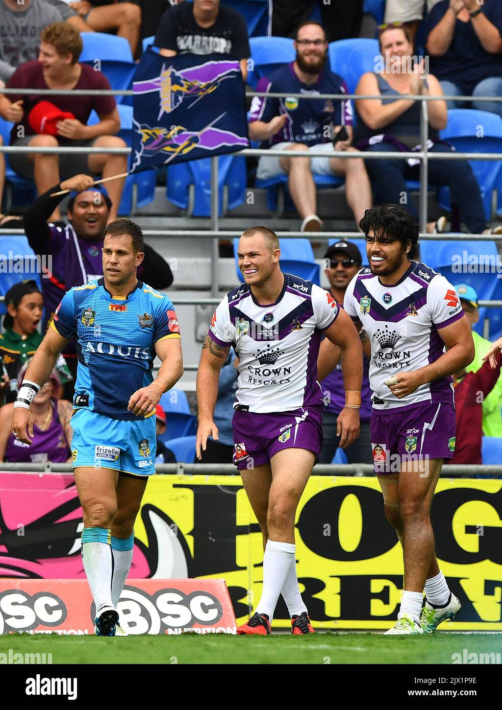 Melbourne Storm player Chase Blair (centre) celebrates after scoring a ...