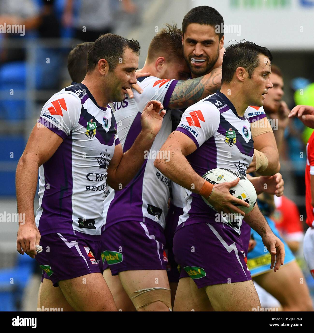Melbourne Storm players celebrate after Cooper Cronk (right) scored a ...