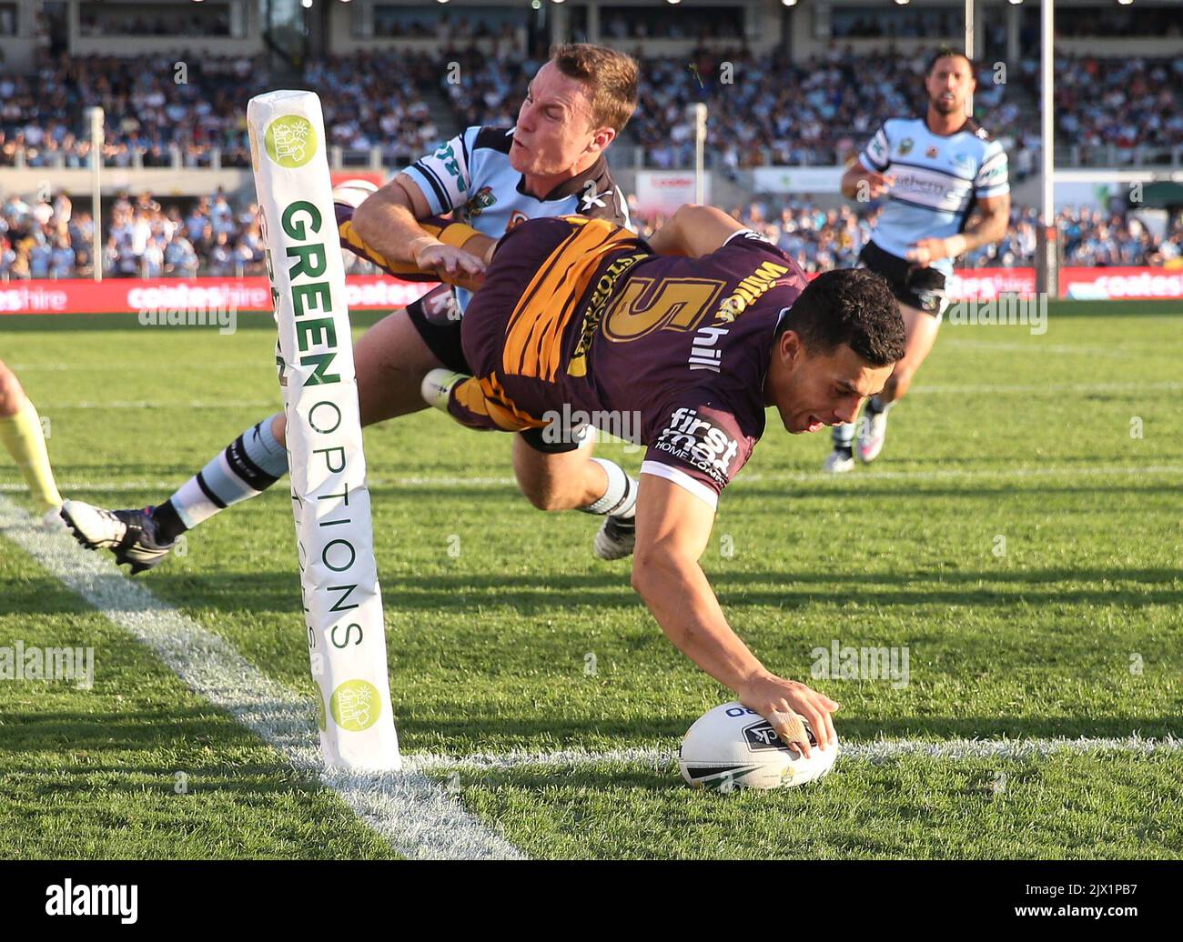 Jordan Kahu of the Broncos beats the tackle of James Maloney of the ...