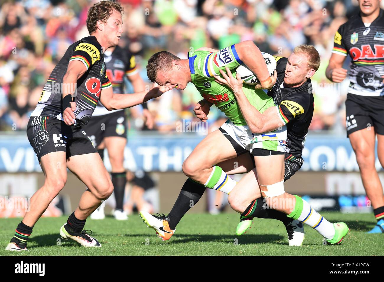 Matthew Moylan and Peter Wallace of the Panthers hold Jack Wighton of ...