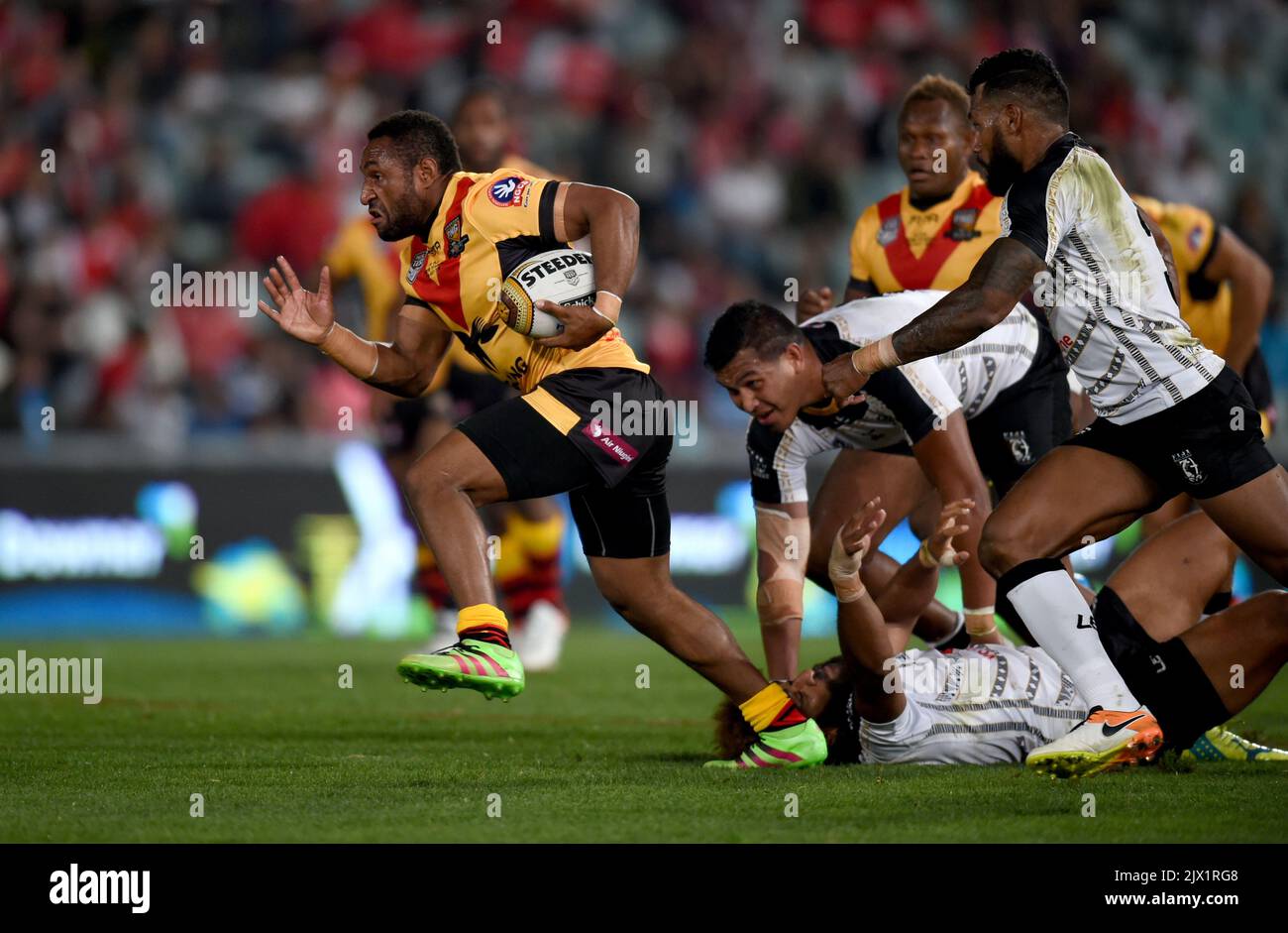 Justin Olam Papua New Guinea evades a tackled by Fuji player in the ...
