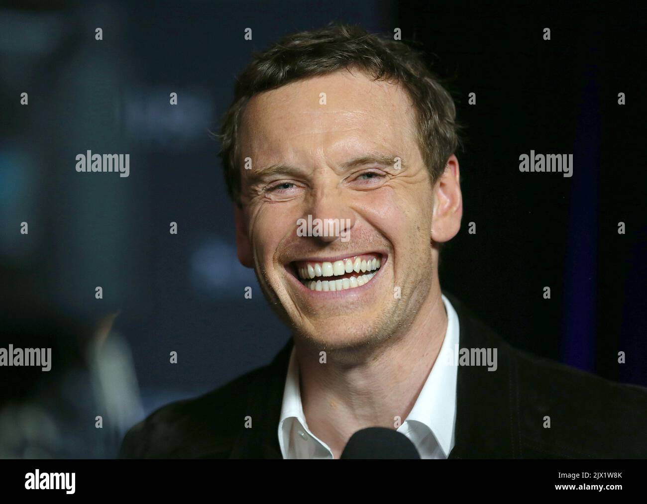 Actor Michael Fassbender, who plays the character Magneto, smiles while ...