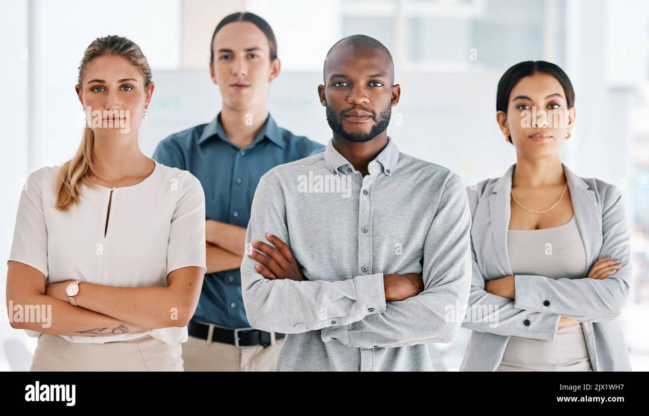 Motivation, arms crossed and serious with business people standing in ...
