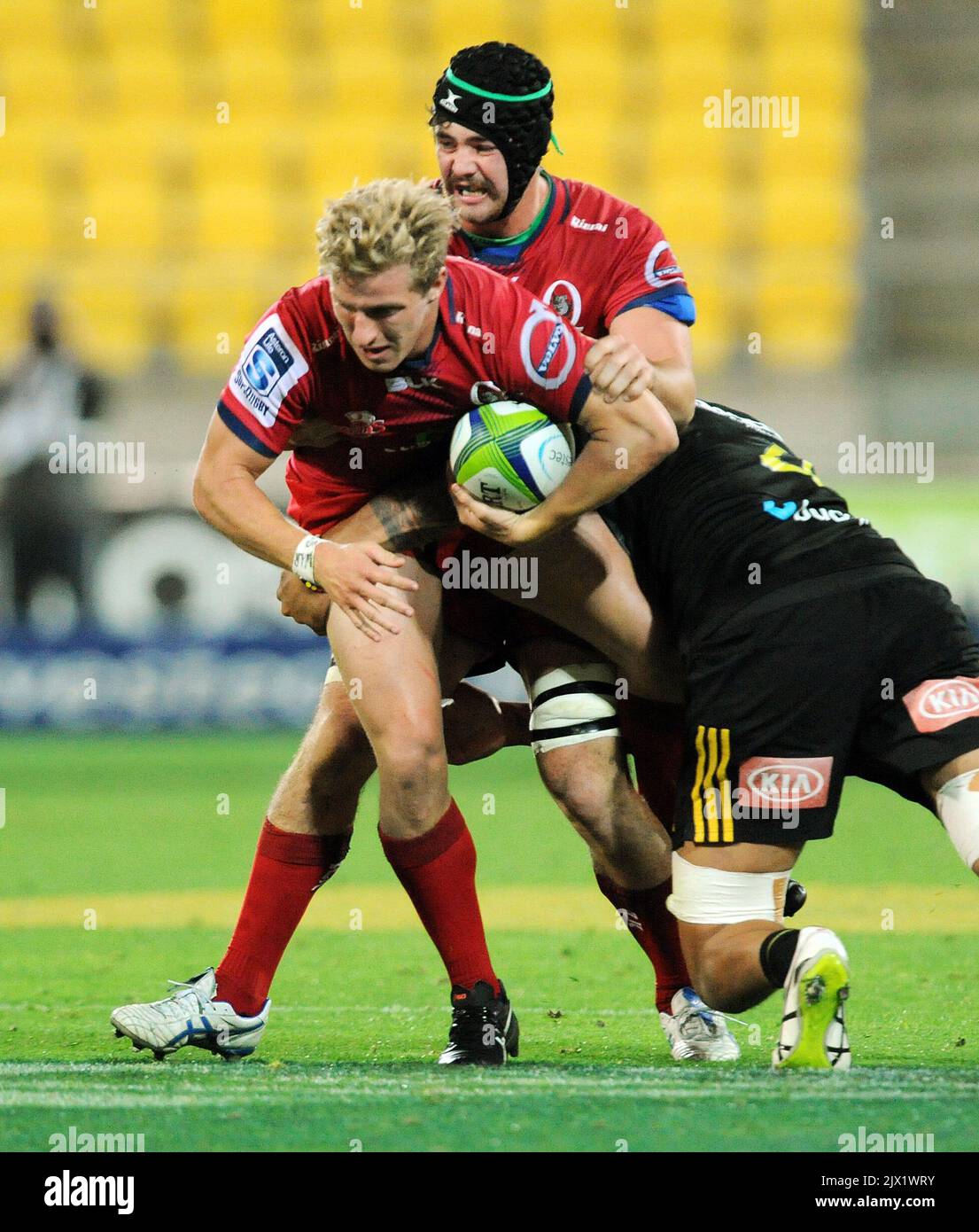 Cadeym Neville of the Reds tackled by Vaea Fifta of the Hurricanes in ...