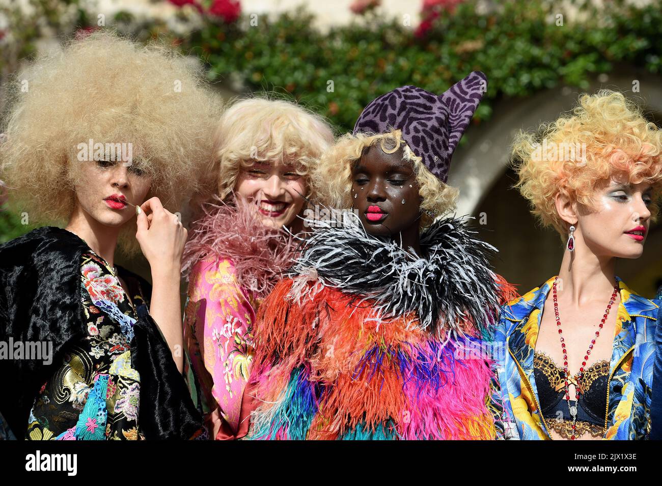 Models pose for a photograph after showing the creations of Australian ...