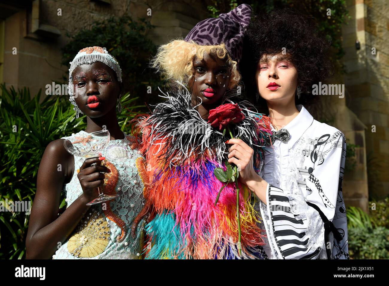 Models pose for a photograph after showing the creations of Australian ...