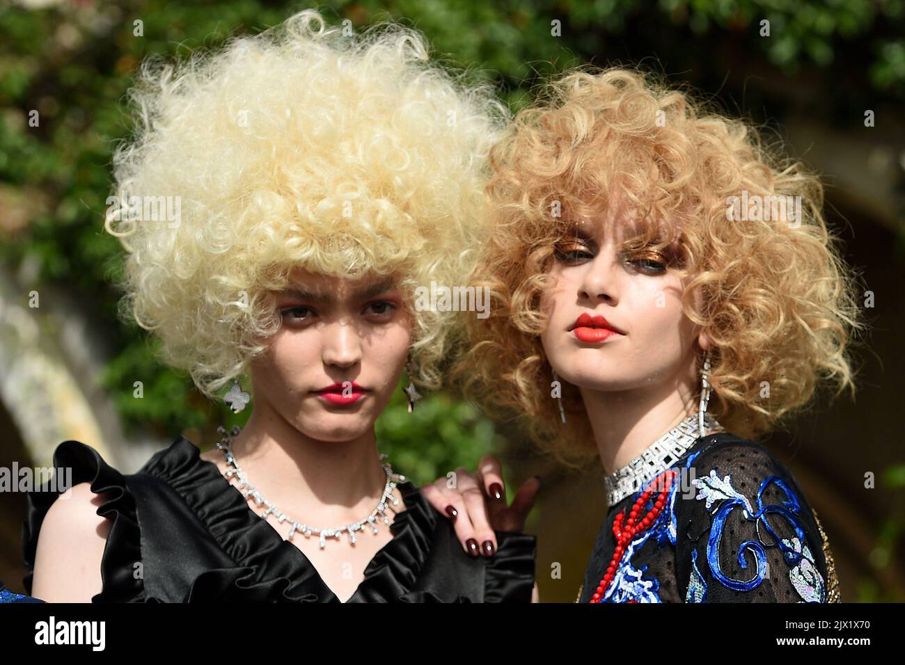 Models pose for a photograph after showing the creations of Australian ...