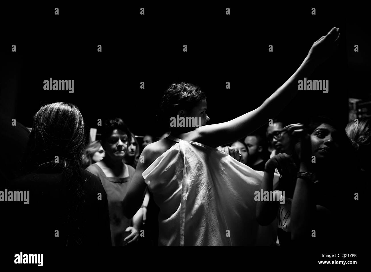 A model gestures backstage ahead of the Akira show, at Mercedes-Benz ...